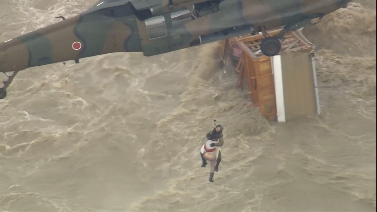 Japan floods: Couple and their dogs rescued from rooftop after Joso ...