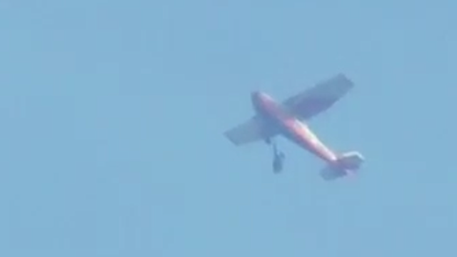 Sky diving video shows man hanging under plane after failed jump ...