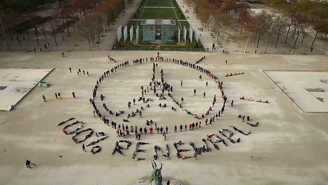 Paris: Hundreds gather to form Eiffel Tower peace symbol for climate ...