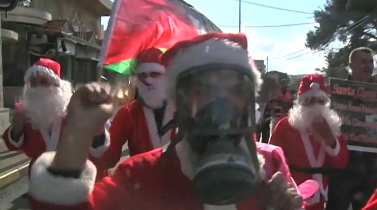 Bethlehem: Palestinian protesters dressed as Santa Claus clash with ...