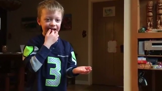 Boy pulls his loose tooth out with a throw of a football | IBTimes UK