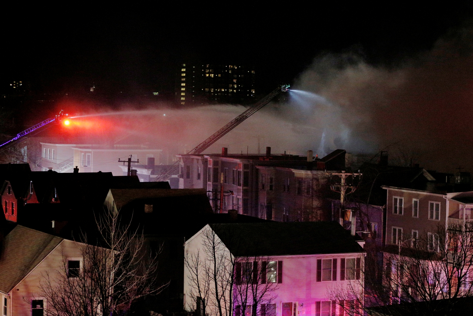 Firefighters battle massive 10-alarm fire engulfing several buildings ...